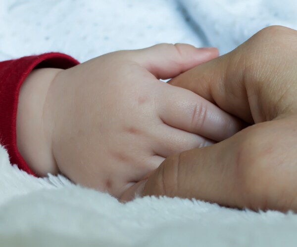 Professor Bruce Johnson Holds Student's Baby During Lecture | Newsmax.com