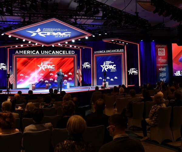 CPAC Attendees Boo Hosts' Requests to Wear Masks | Newsmax.com